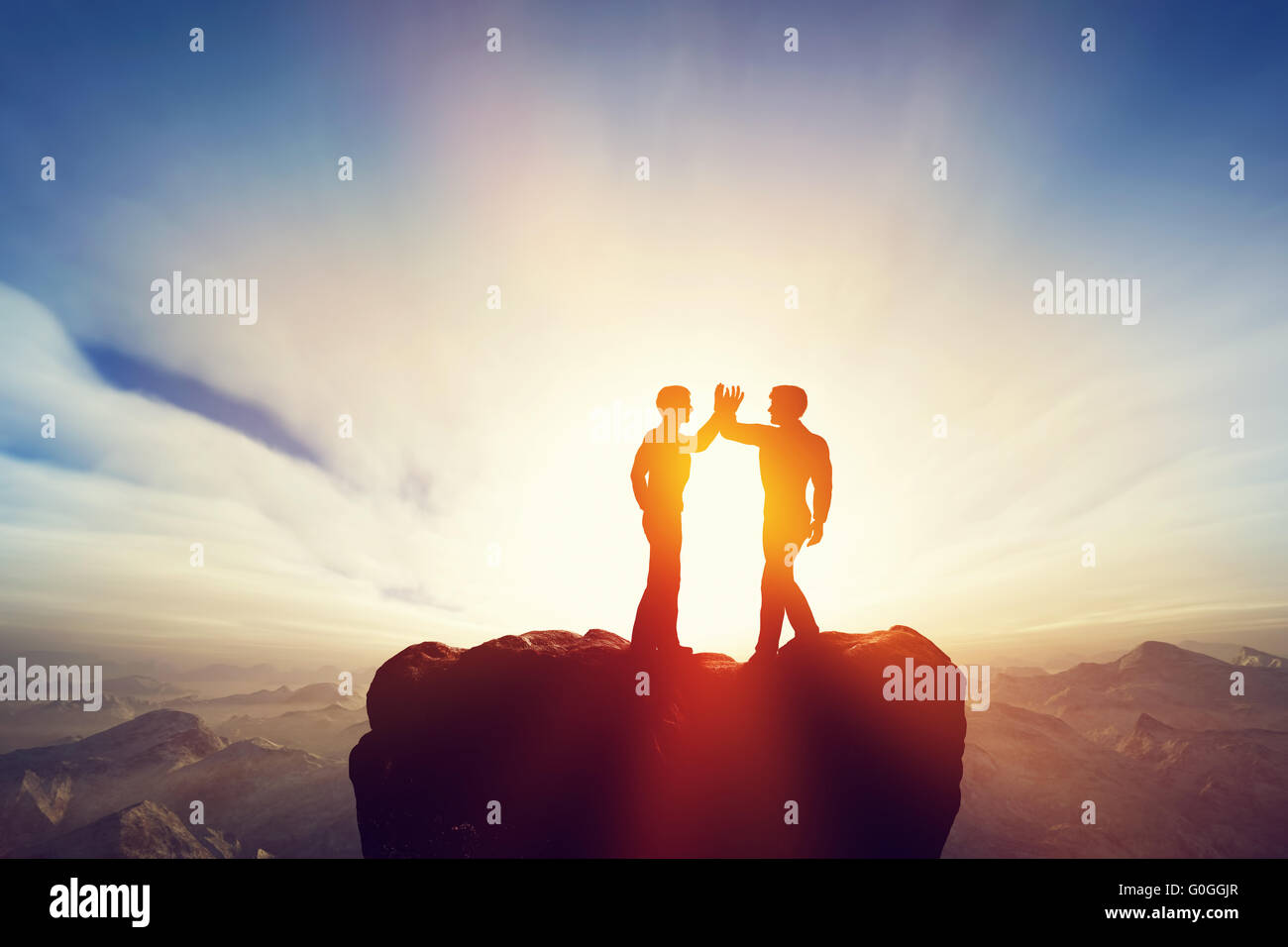 Two men, friends high five on top of the mountains. Agreement Stock ...