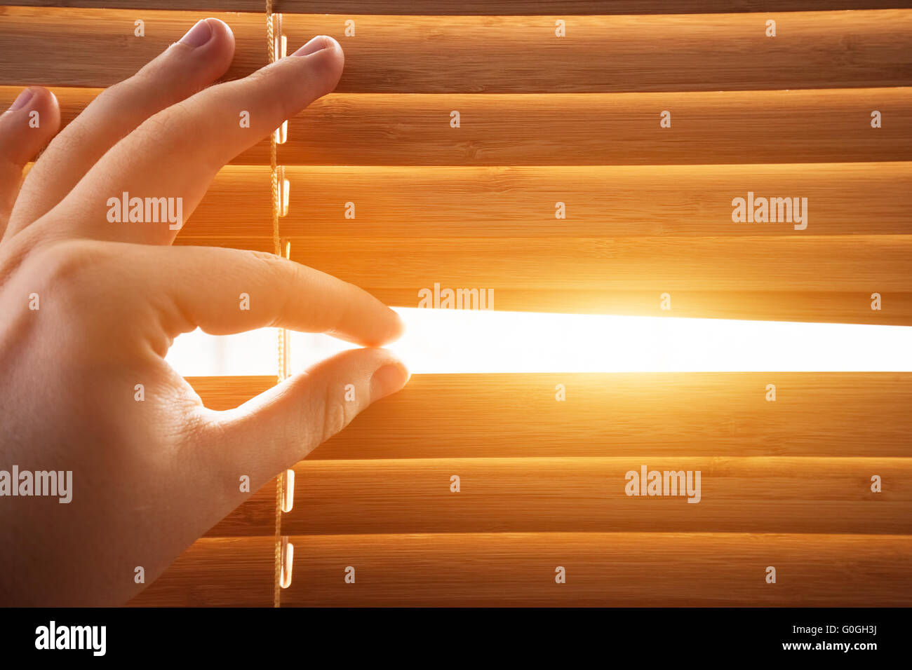 Looking through window blinds, sun light coming inside Stock Photo - Alamy