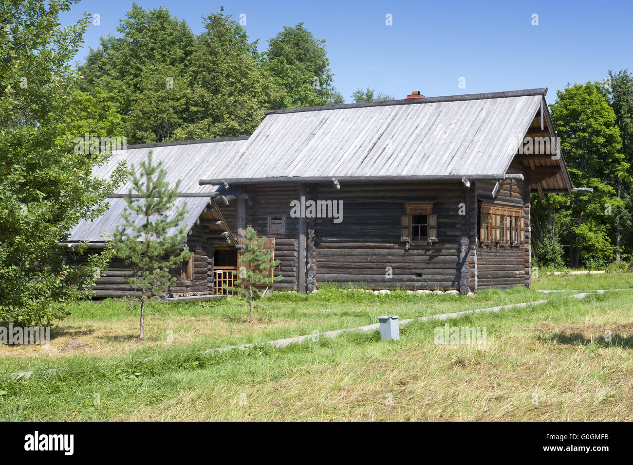 ancient log hut on a forest glade. Russia Stock Photo - Alamy