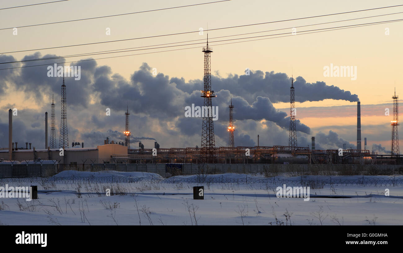 Refinery at sunset sky background. Frosty snowy winter evening Stock ...