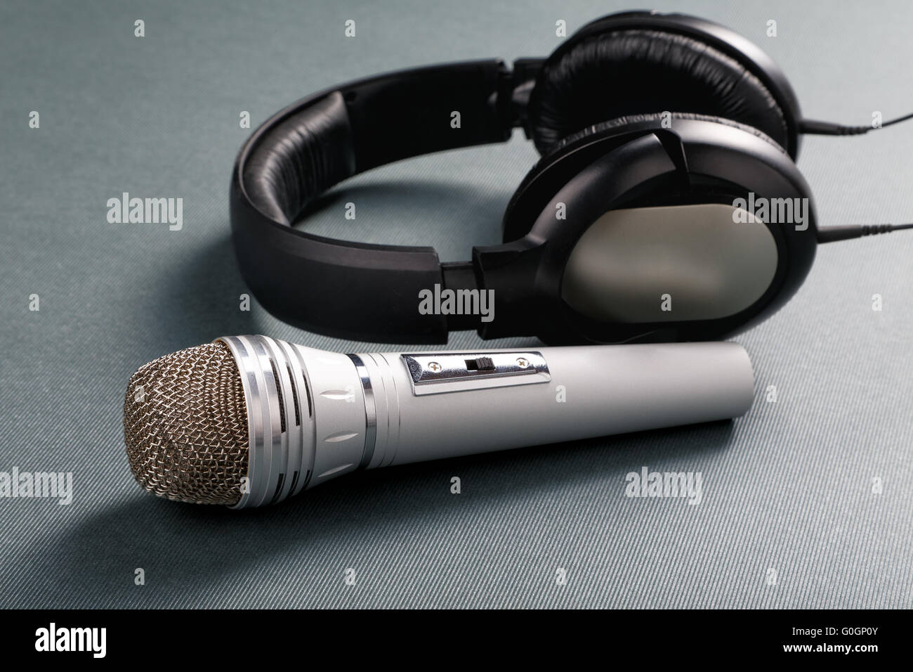 Microphone and ear-phones on a table Stock Photo - Alamy