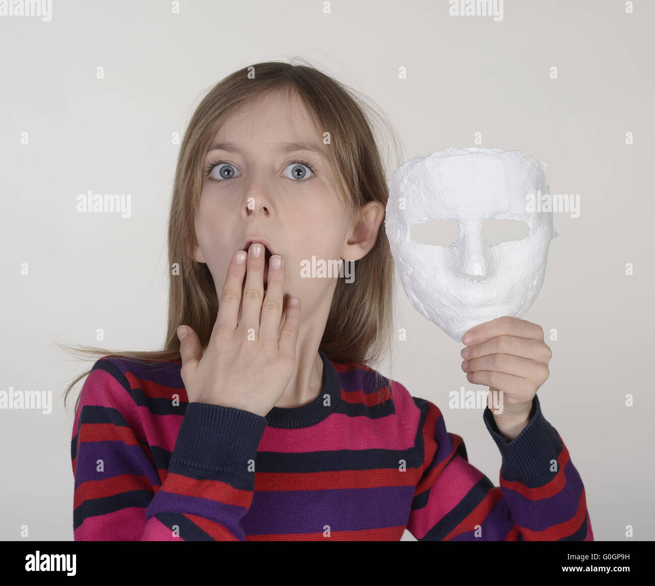 afraid little girl with plaster mask Stock Photo - Alamy