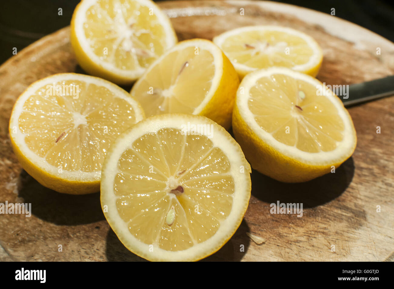 Chopped fresh lemons on wooden mat closeup Stock Photo - Alamy