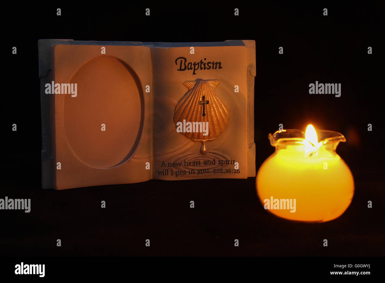 Baptism photo frame in candle light Stock Photo - Alamy