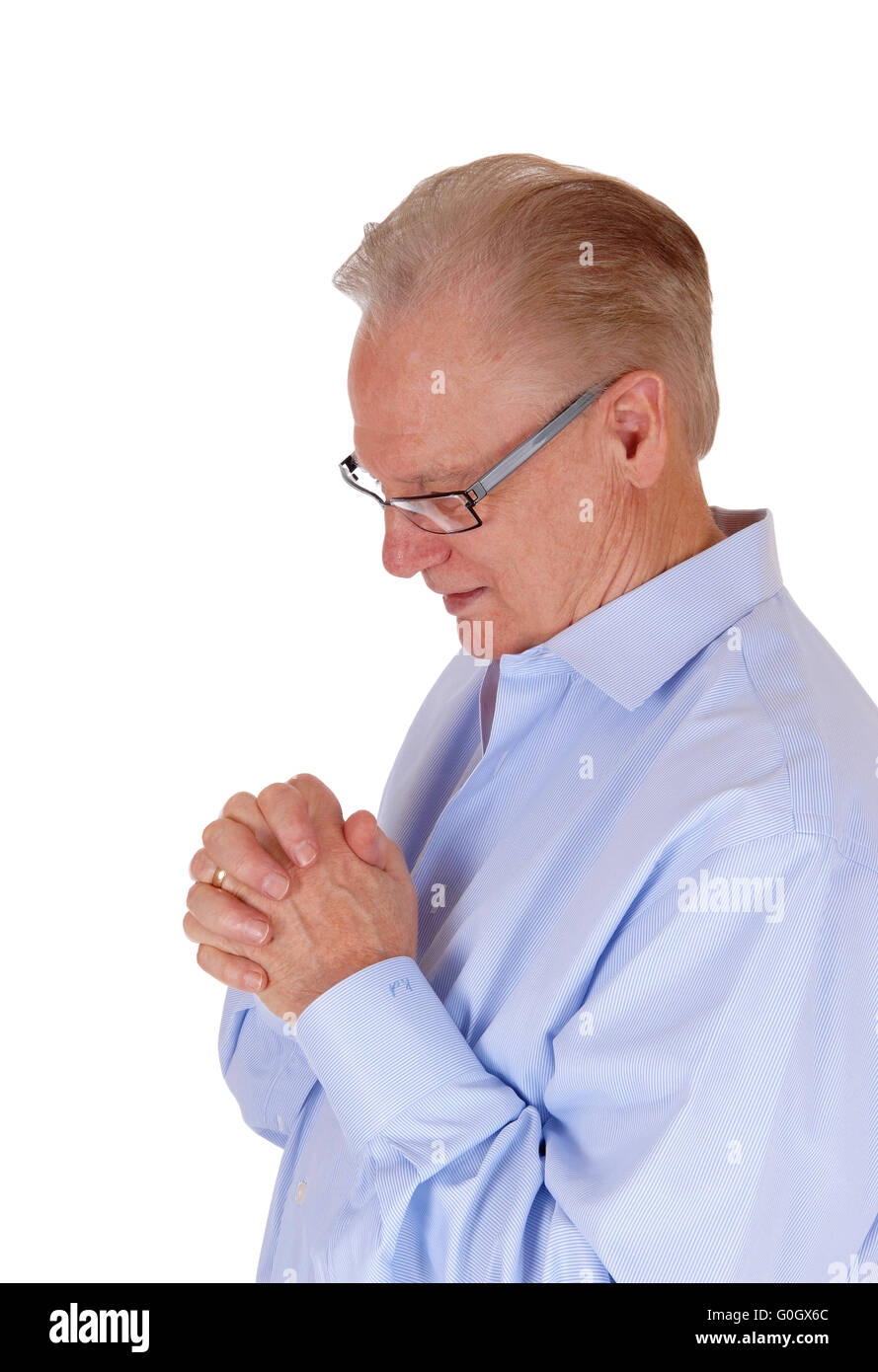 Praying senior man with folded hands Stock Photo - Alamy