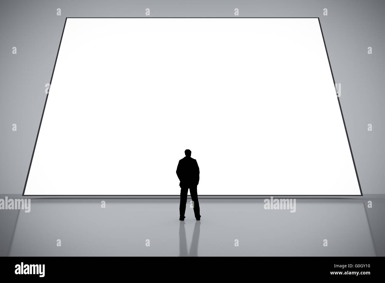 man in front of a big white screen Stock Photo - Alamy