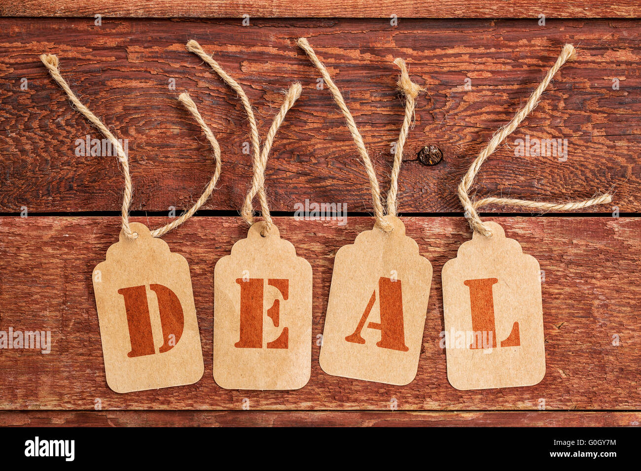 deal sign or concept - letters on price tags against rustic red painted ...