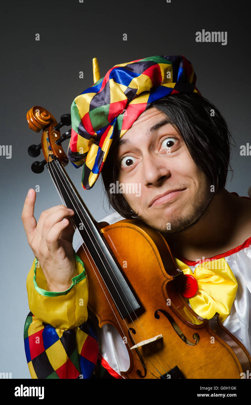 Funny violin clown player in musical concept Stock Photo - Alamy