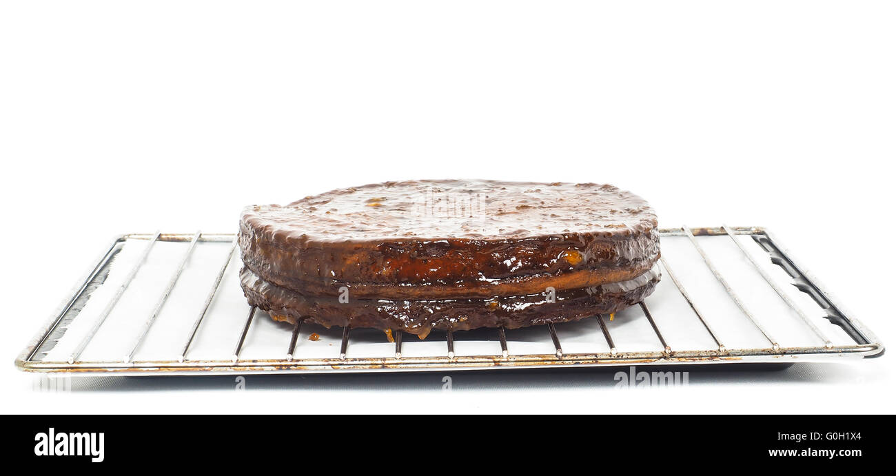 Half stage on sacher torte chocolate cake on grid before chocolate ...