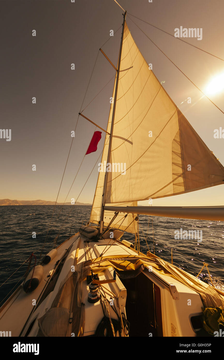 Sailing boat wide angle view in the sea at sunset Stock Photo - Alamy