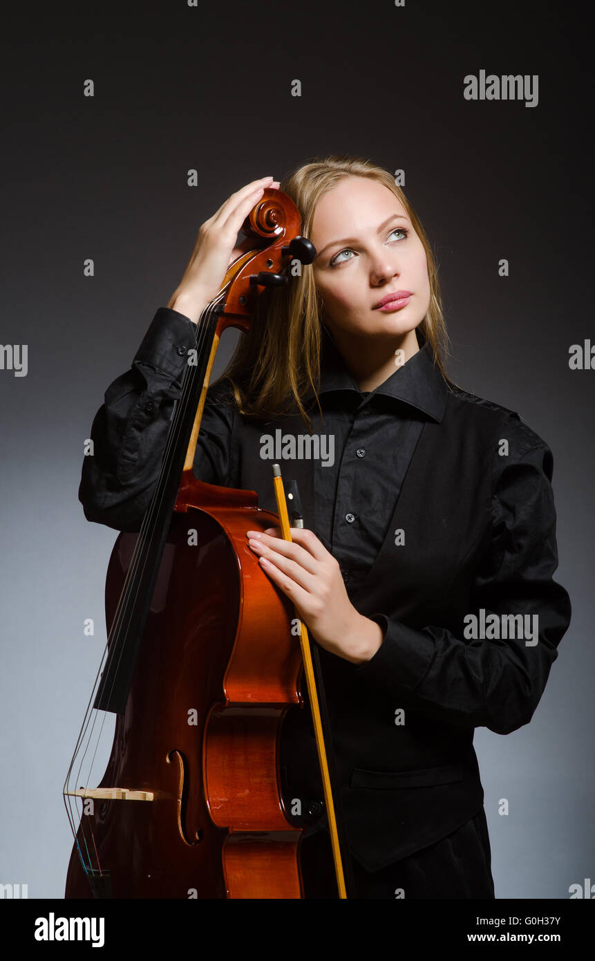 Woman playing classical cello in music concept Stock Photo - Alamy