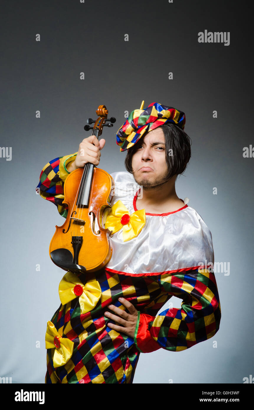 Funny violin clown player in musical concept Stock Photo - Alamy