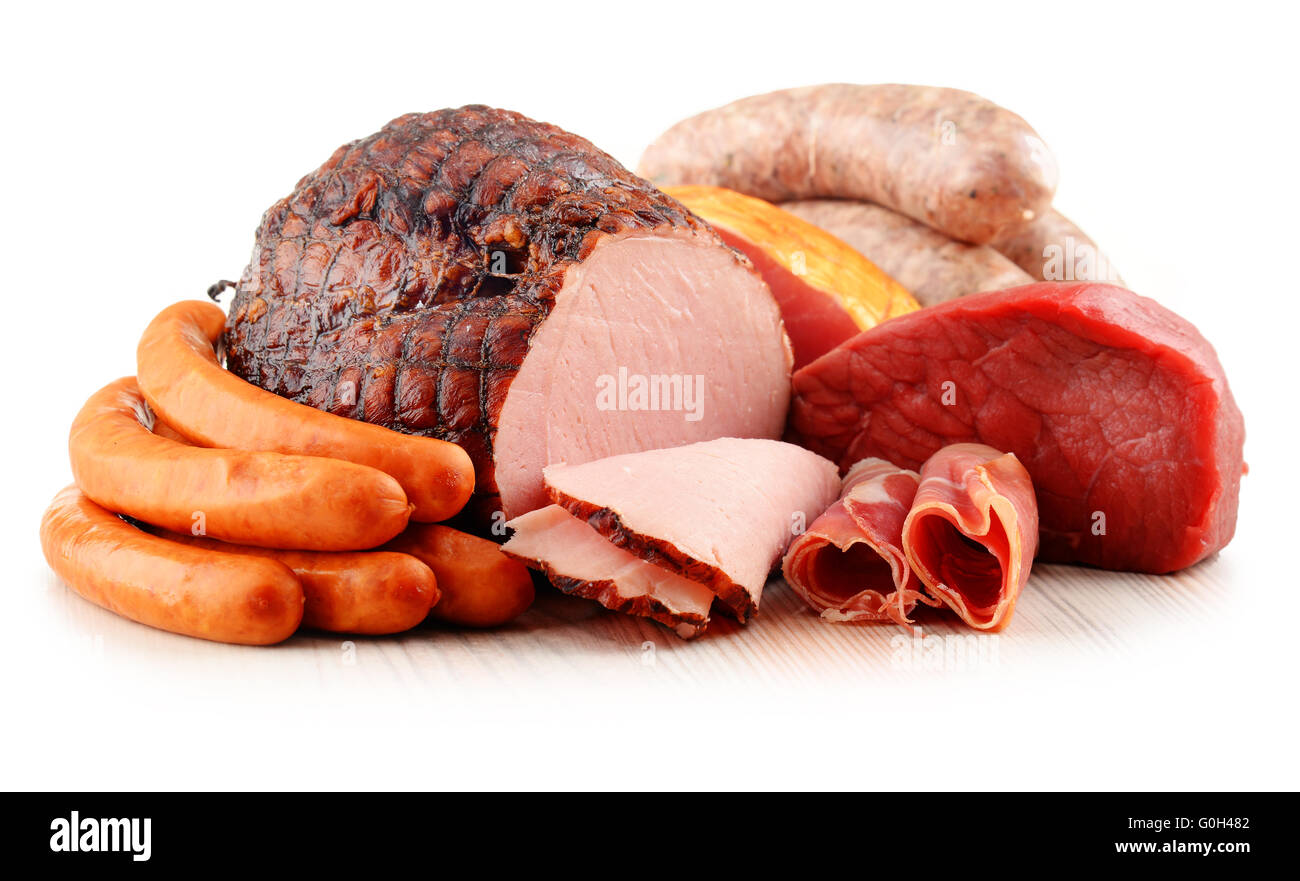 Assorted meat products including ham and sausages isolated on white ...