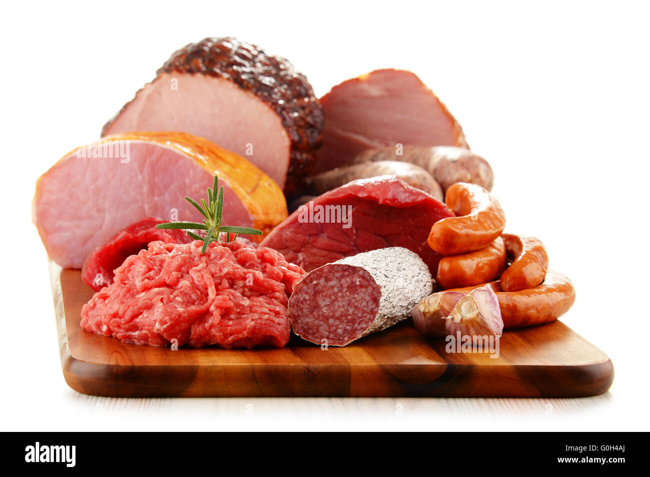 Assorted meat products including ham and sausages isolated on white ...