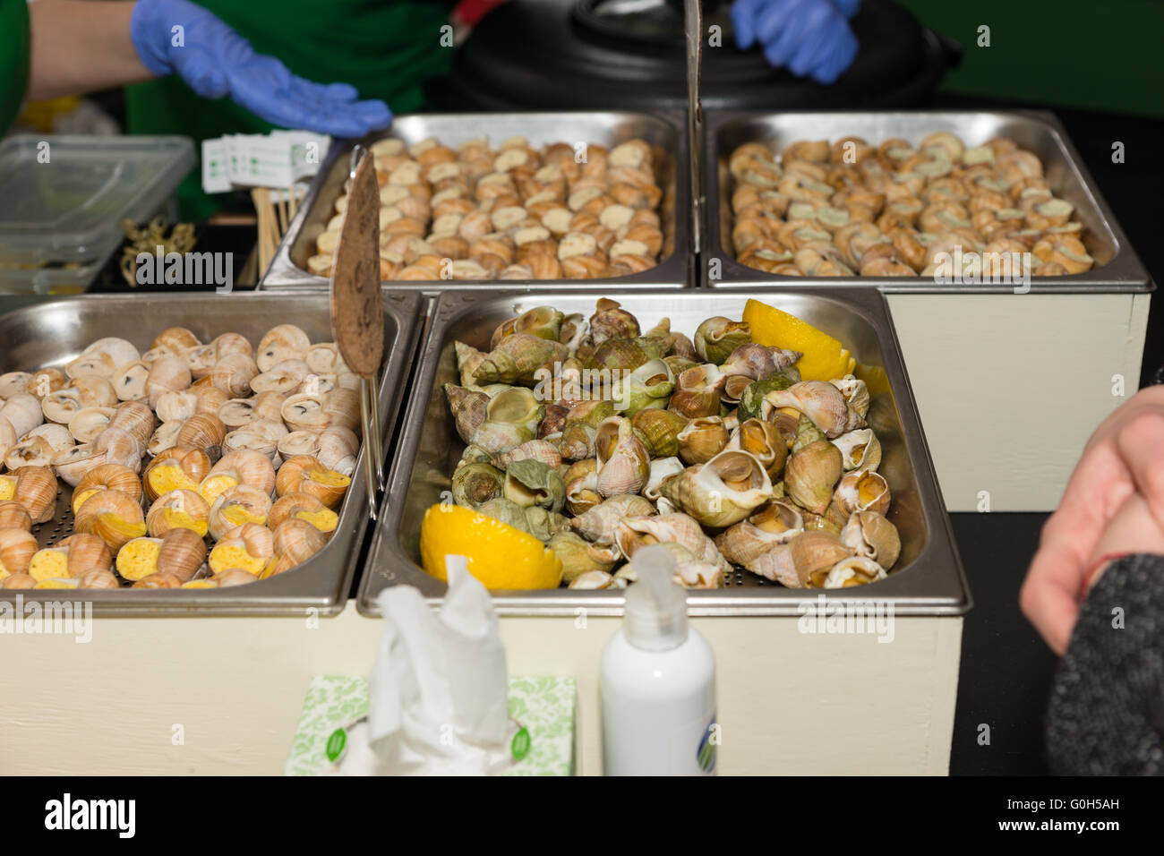 Trays of gourmet stuffed snails on display with an assorted variety of ...