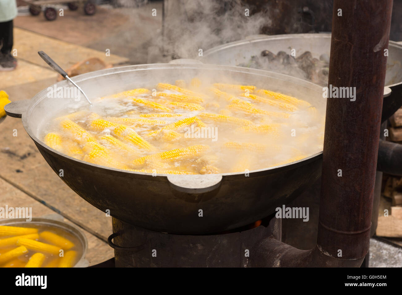 Large commercial pot attached to a burner of cooking corn on the cob ...