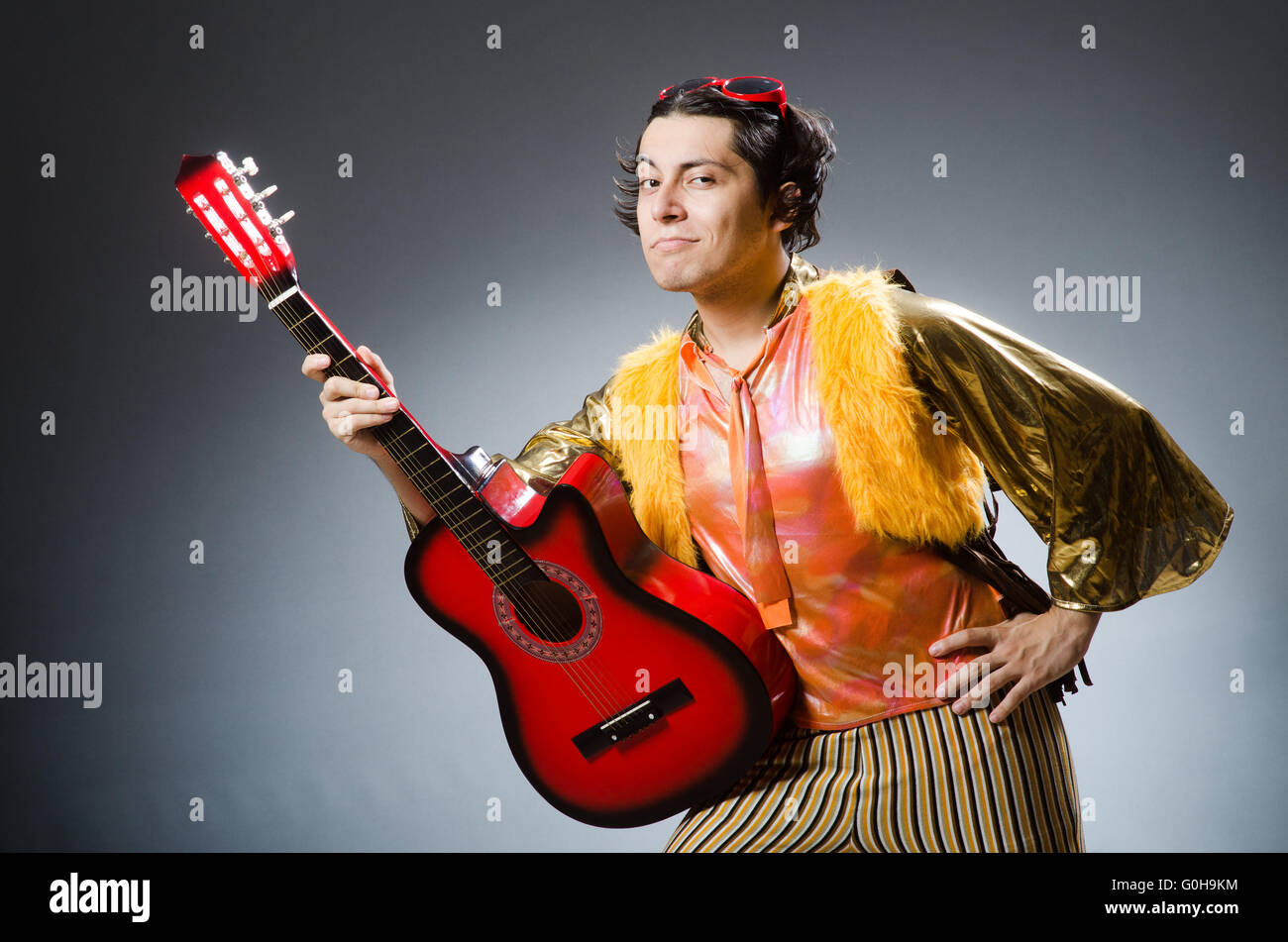 Man with guitar in musical concept Stock Photo - Alamy