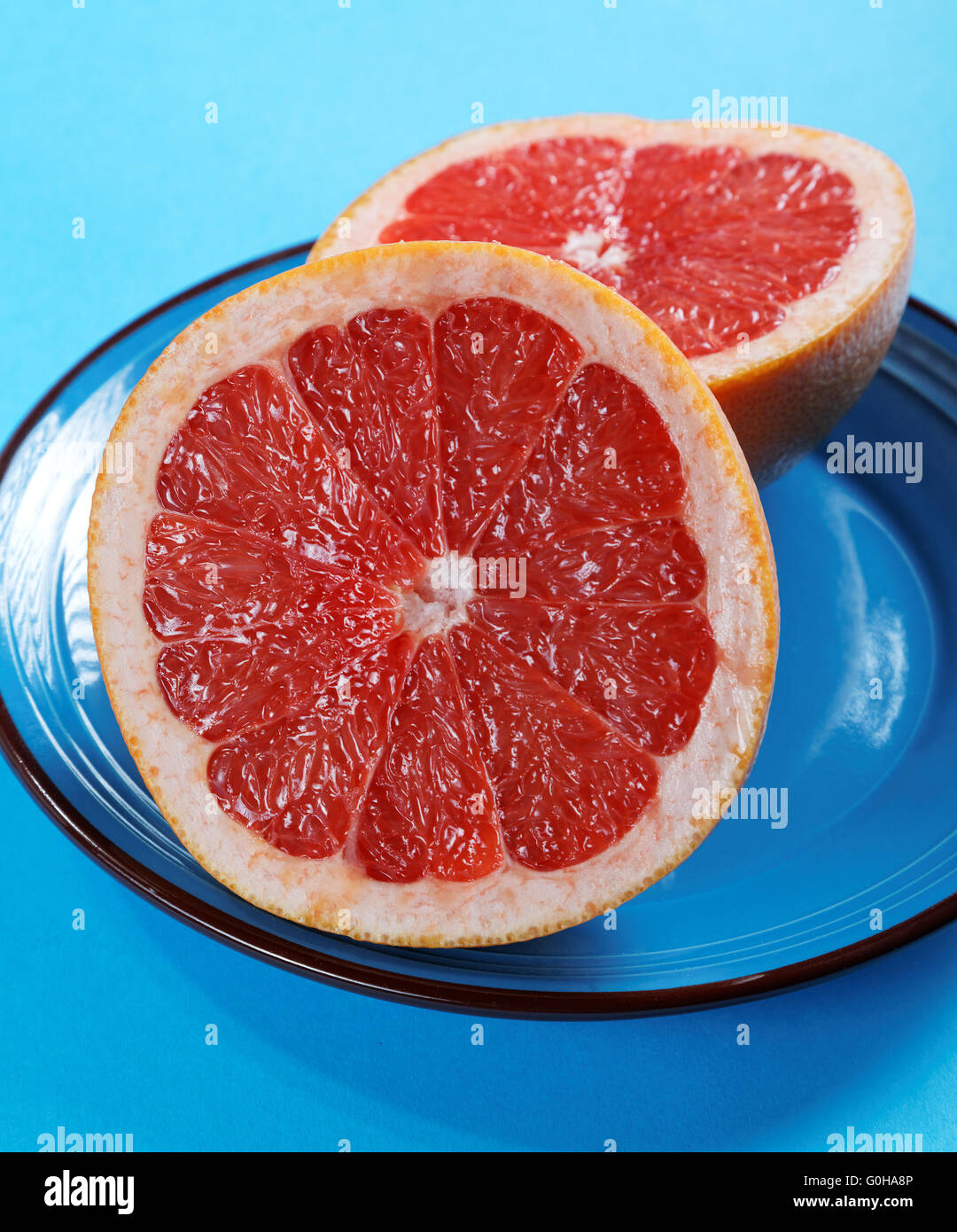 Grapefruit halves close-up on a plate Stock Photo - Alamy