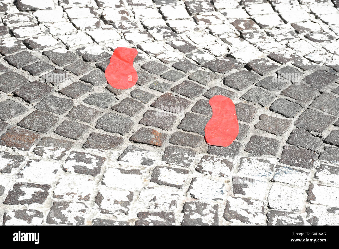 Red footsteps in town Stock Photo - Alamy