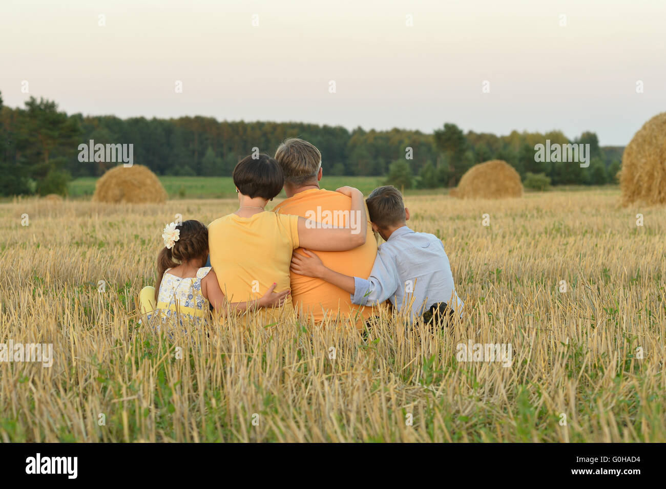 happy family at field Stock Photo - Alamy