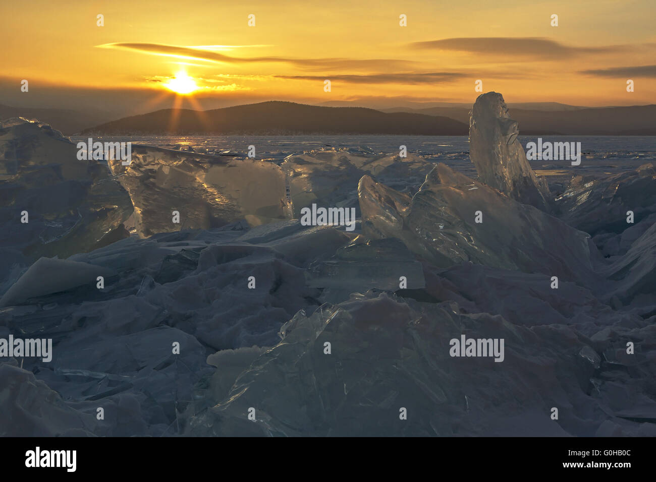 Transparent pieces of ice and the rising sun Stock Photo - Alamy