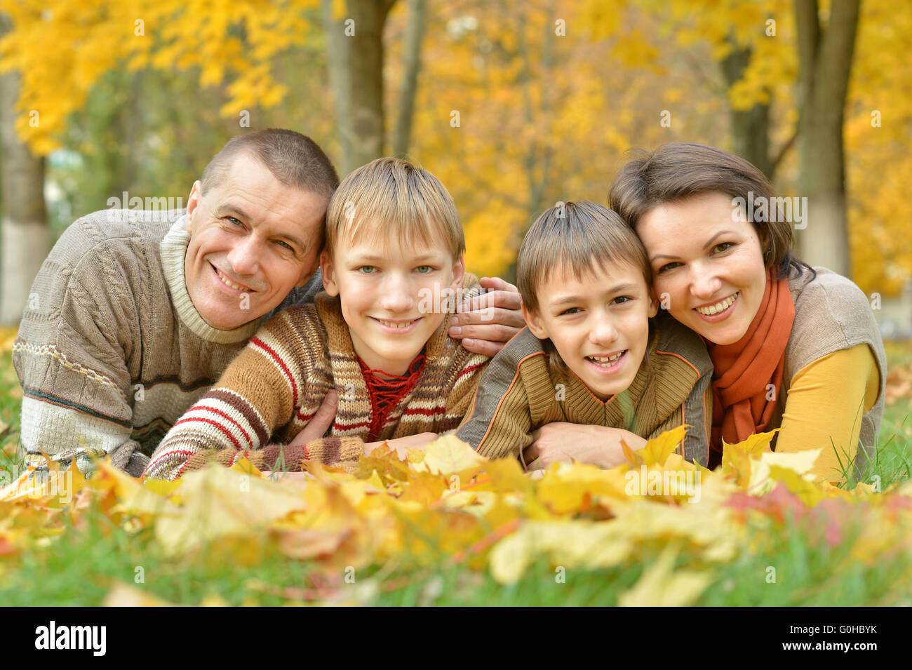 Family in autumn park Stock Photo - Alamy