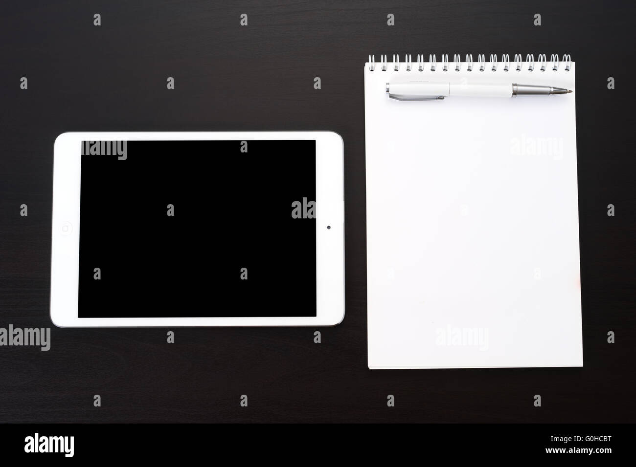 Digital tablet and notepad on office table Stock Photo - Alamy