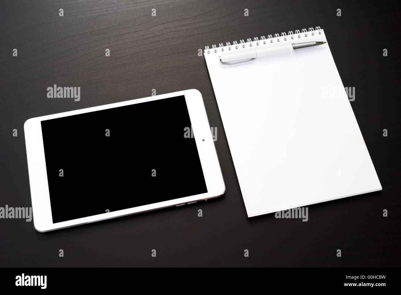 Digital tablet and notepad on office table Stock Photo - Alamy