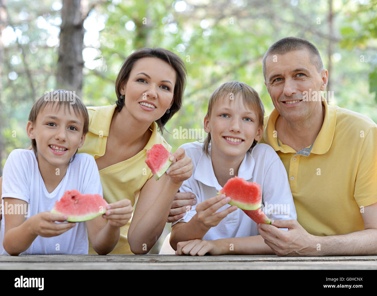 Happy family eating Stock Photo - Alamy