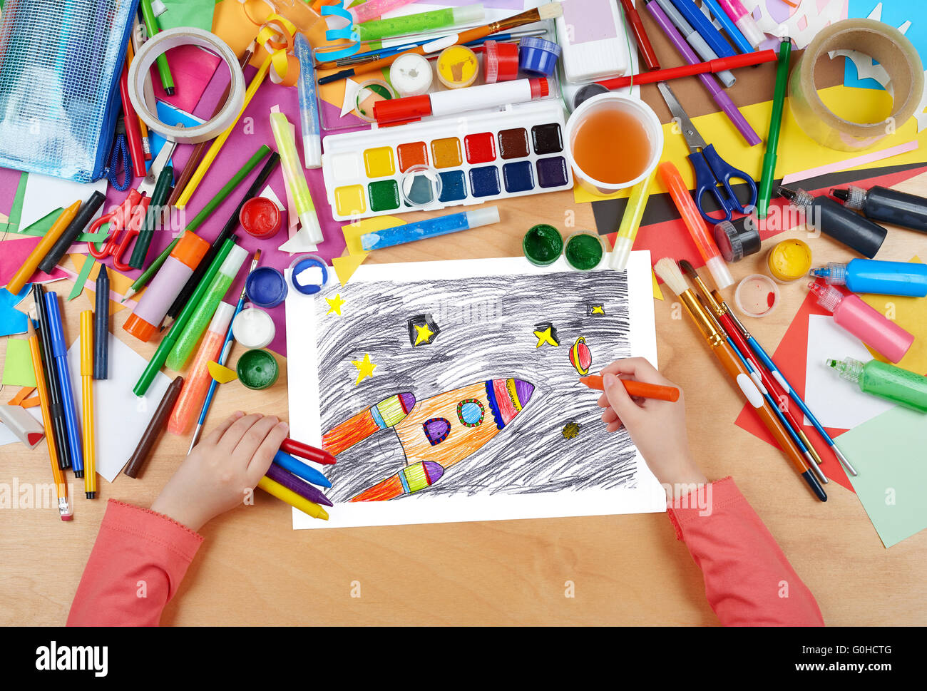 space ship fly and planet child drawing, top view hands with pencil ...