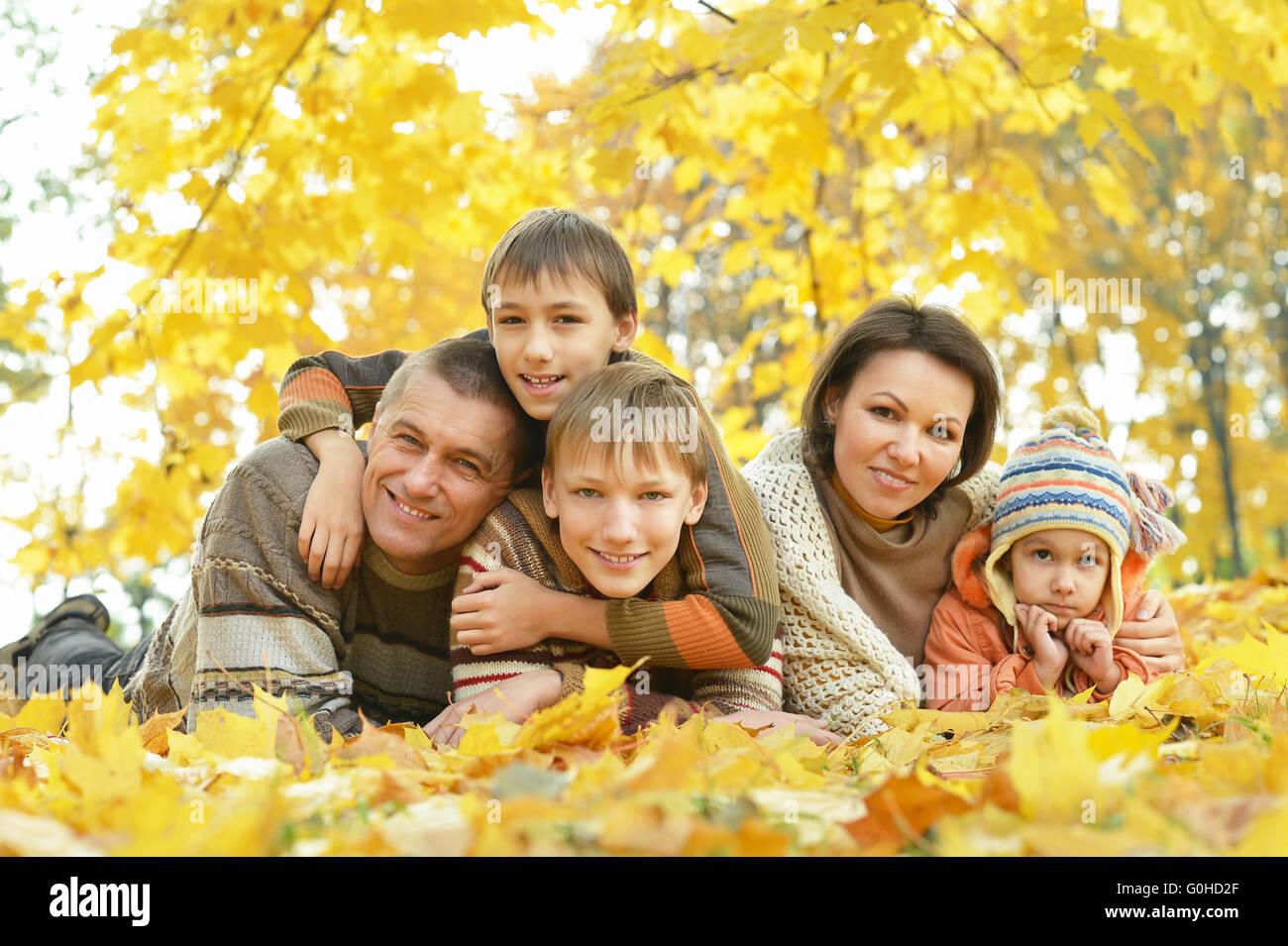Happy family in autumn forest Stock Photo - Alamy