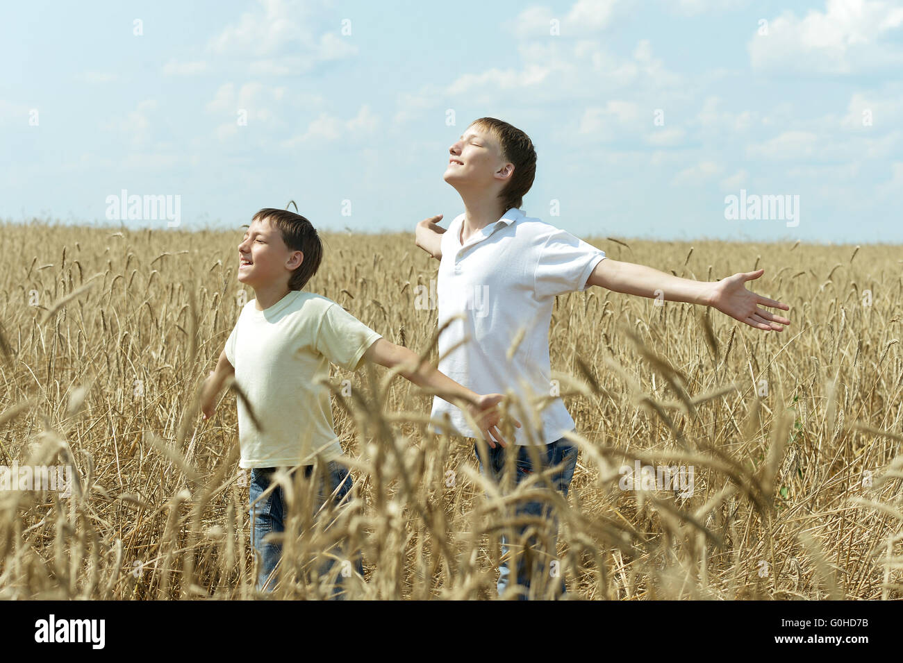 Boys standing at field Stock Photo - Alamy