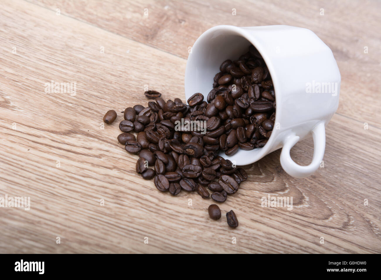 Coffee spill out of a white cup Stock Photo - Alamy