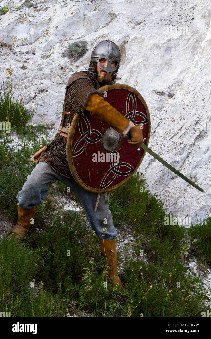 Knight on a rock with a sword Stock Photo - Alamy
