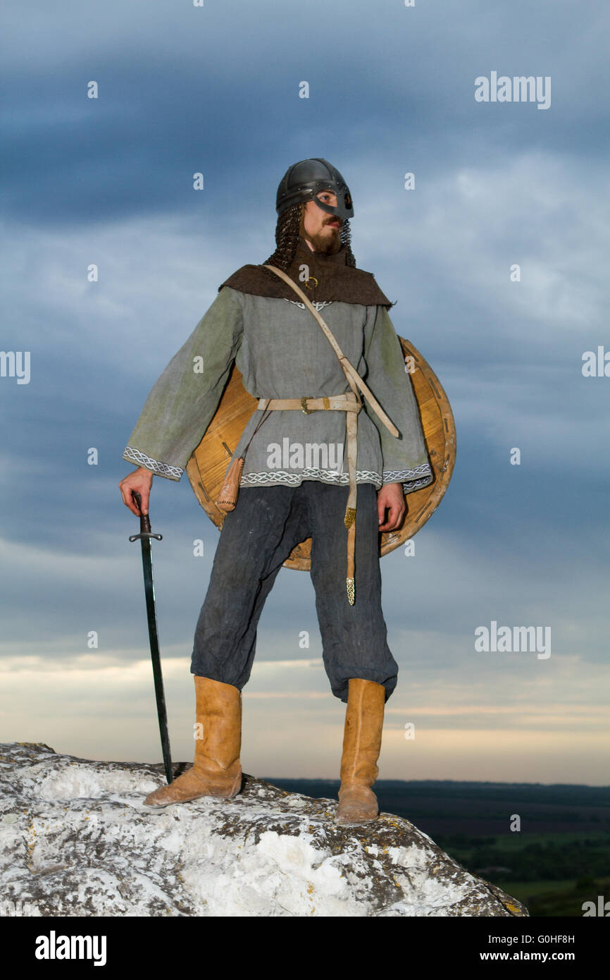 Knight on a rock with a sword Stock Photo - Alamy