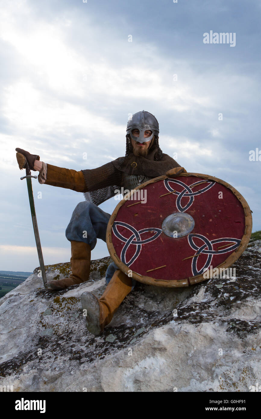 Knight sitting on a rock Stock Photo - Alamy