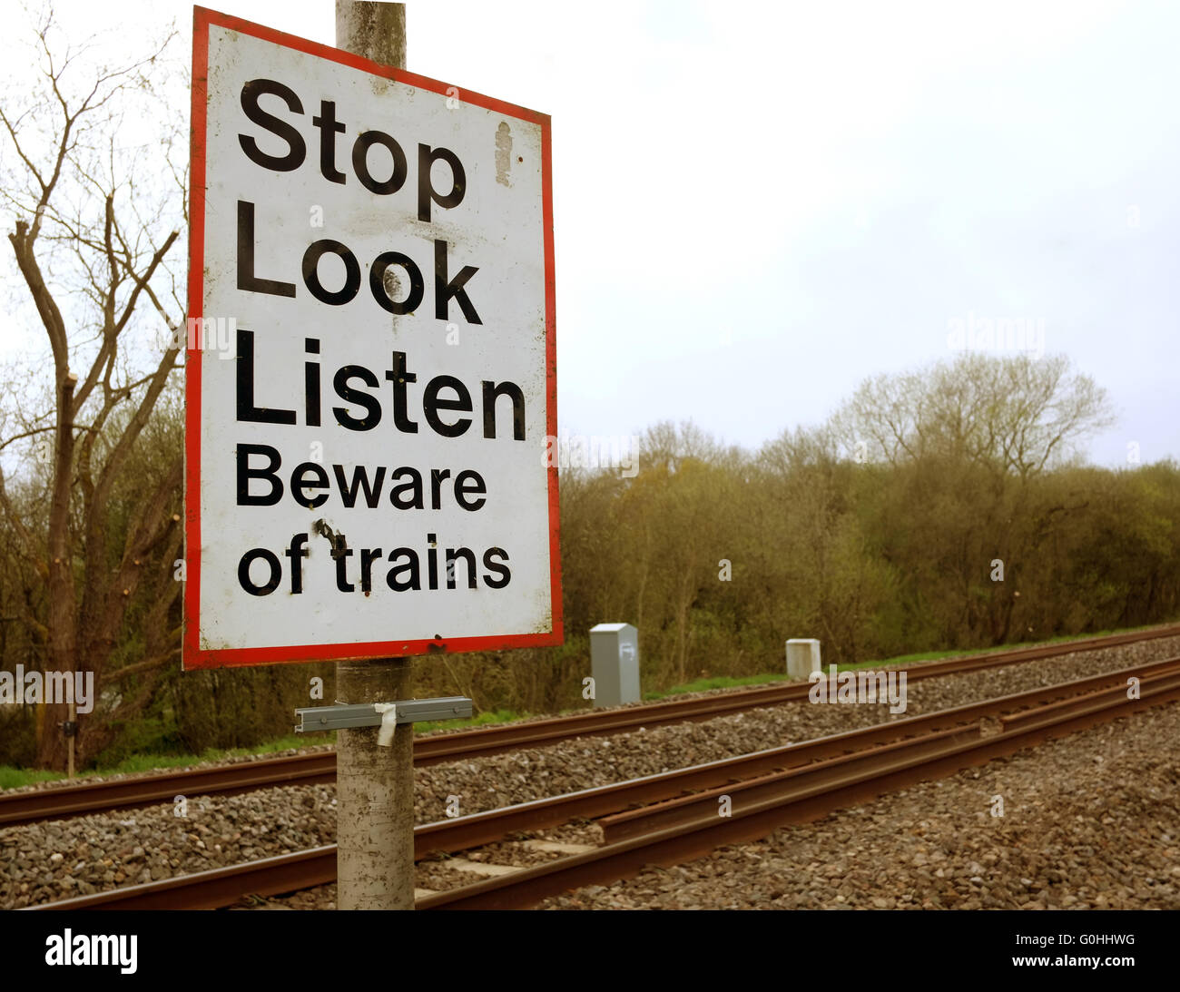 Stop, look, listen, Beware of trains warning sign on a rail pedestrian ...
