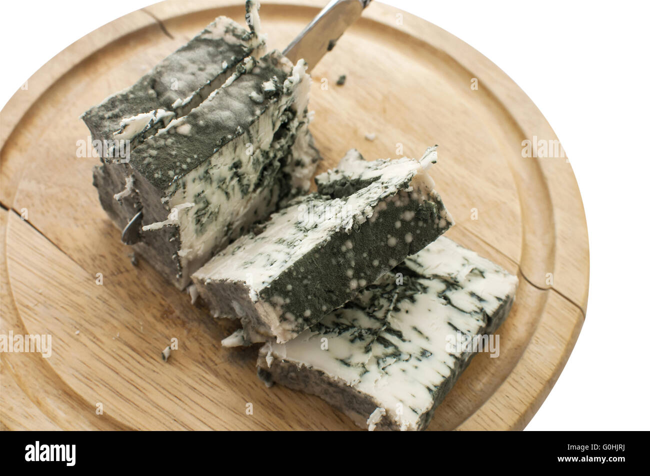 Sliced moldy lump of white cheese and knife on wooden tray isolated on ...