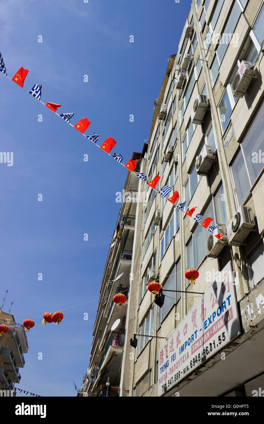 Row of top lit Chinese red overhead lanterns ornaments, flags and ...