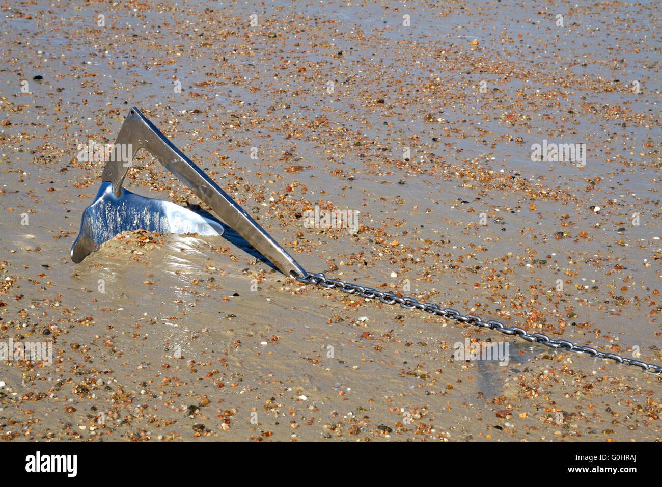 Marine anchor on a sandy beach Stock Photo - Alamy