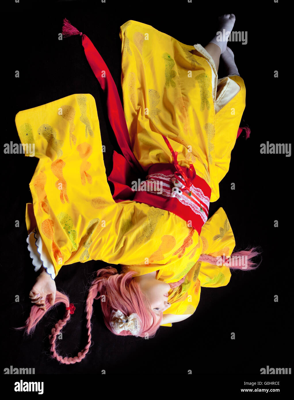 Beauty girl lay in yellow kimono cosplay costume Stock Photo - Alamy
