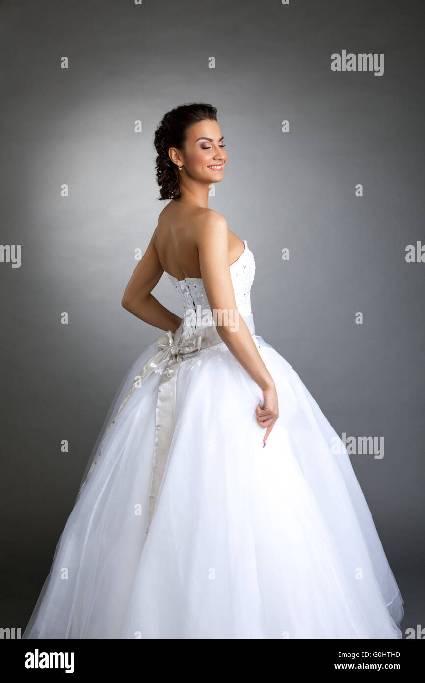 Cheerful model posing in wedding dress, close-up Stock Photo - Alamy