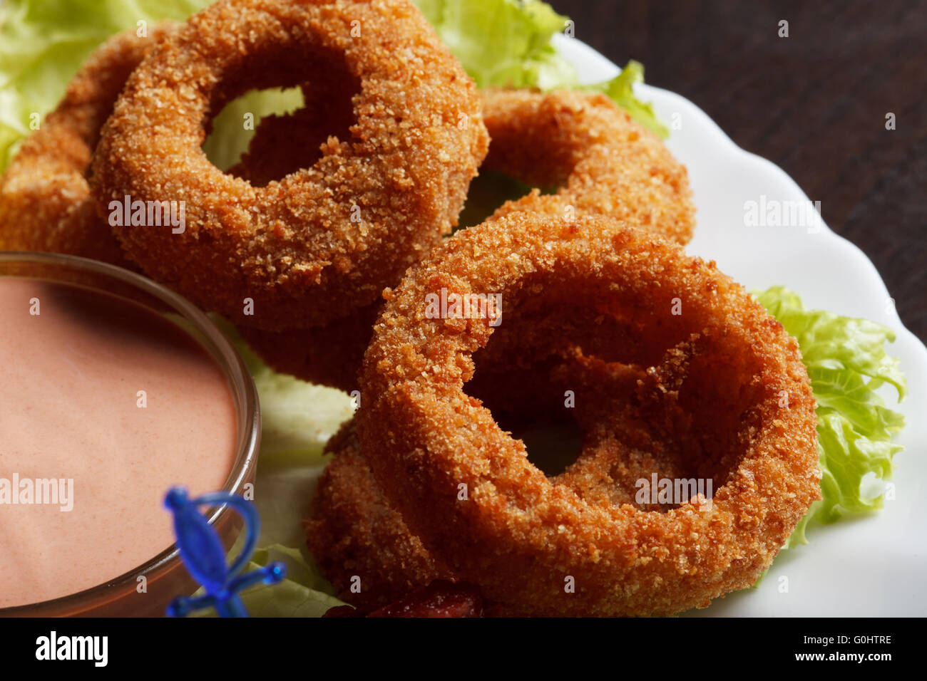 Image of meat breaded rings served with sauce Stock Photo - Alamy