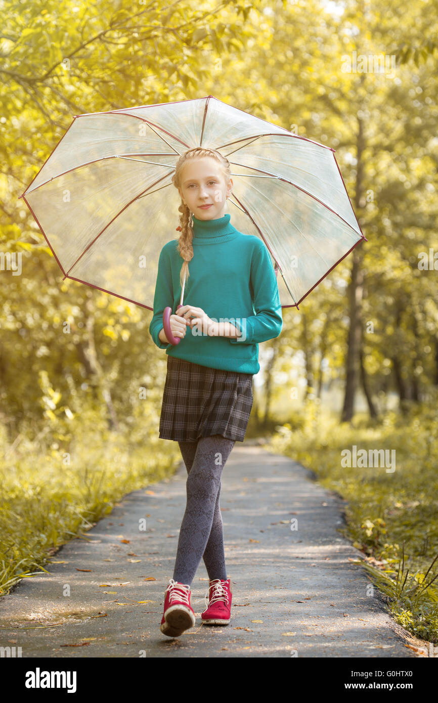 Adorable little girl posing with umbrella in park Stock Photo - Alamy