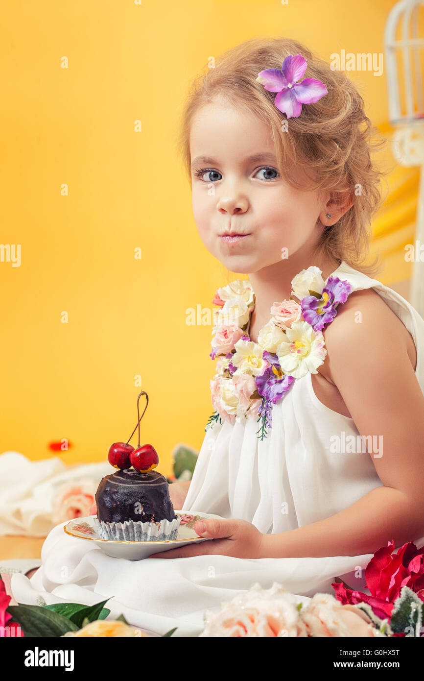 Portrait of slyly smiling girl posing with cake Stock Photo - Alamy