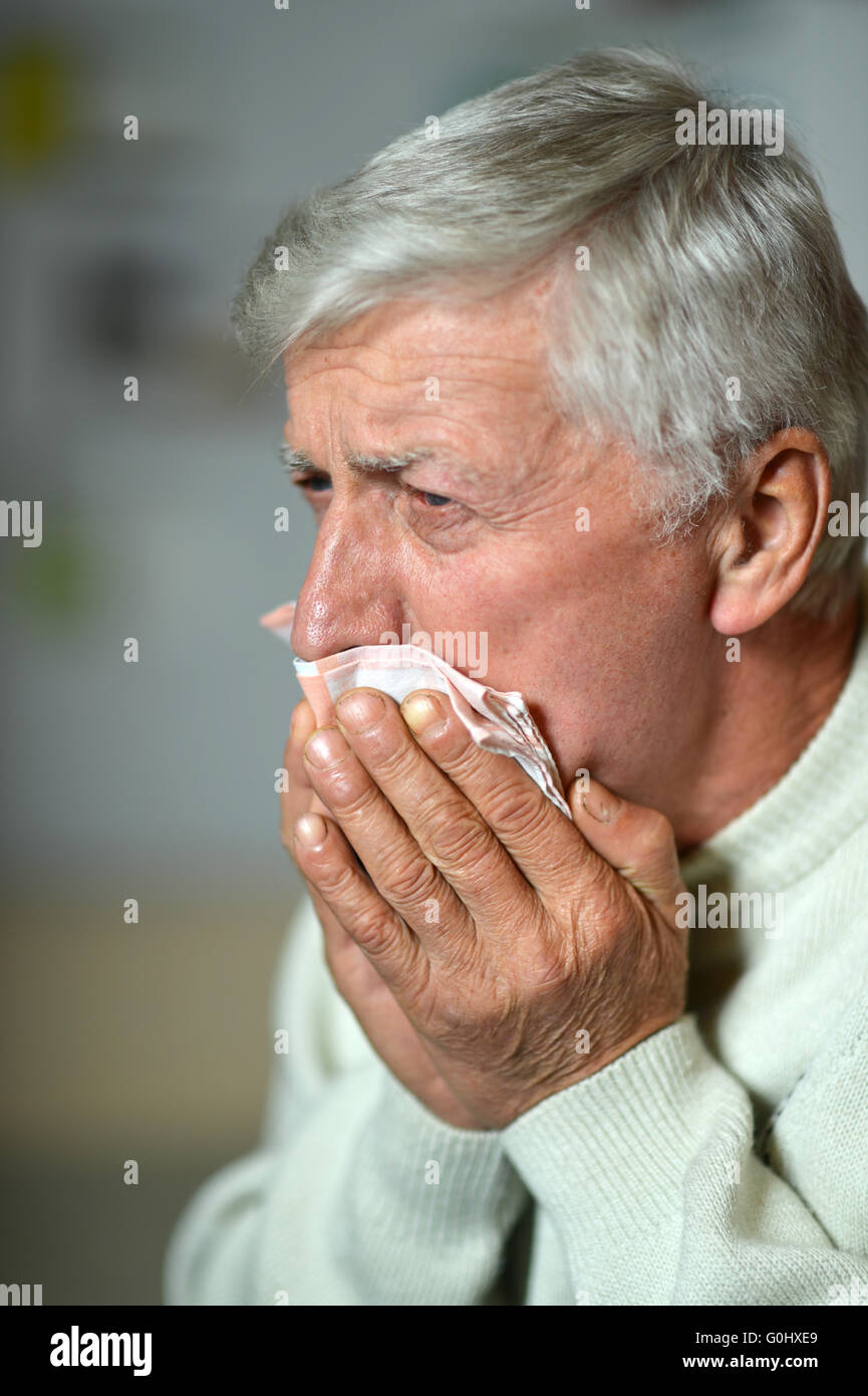 Sick old man on grey Stock Photo - Alamy