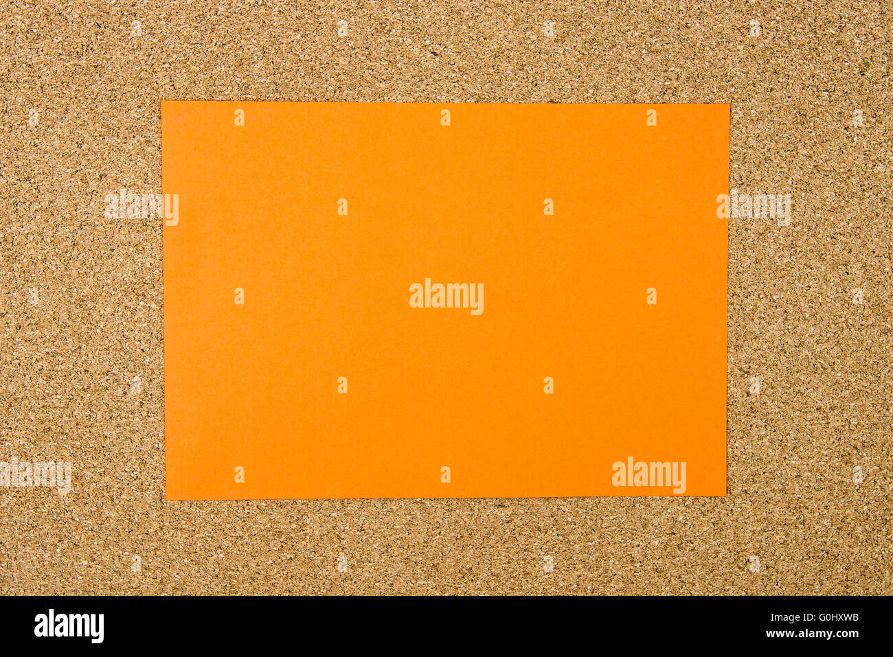 Blank orange paper note over cork board background, copy space ...