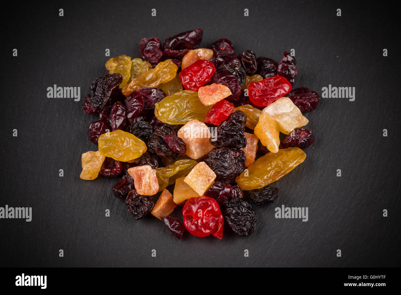 Mix variety of dried fruiton black dark stone background Stock Photo ...