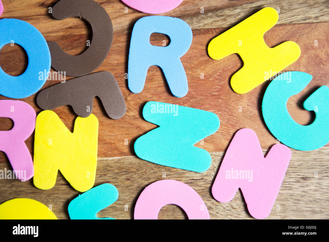 colorful letters on wooden background Stock Photo - Alamy