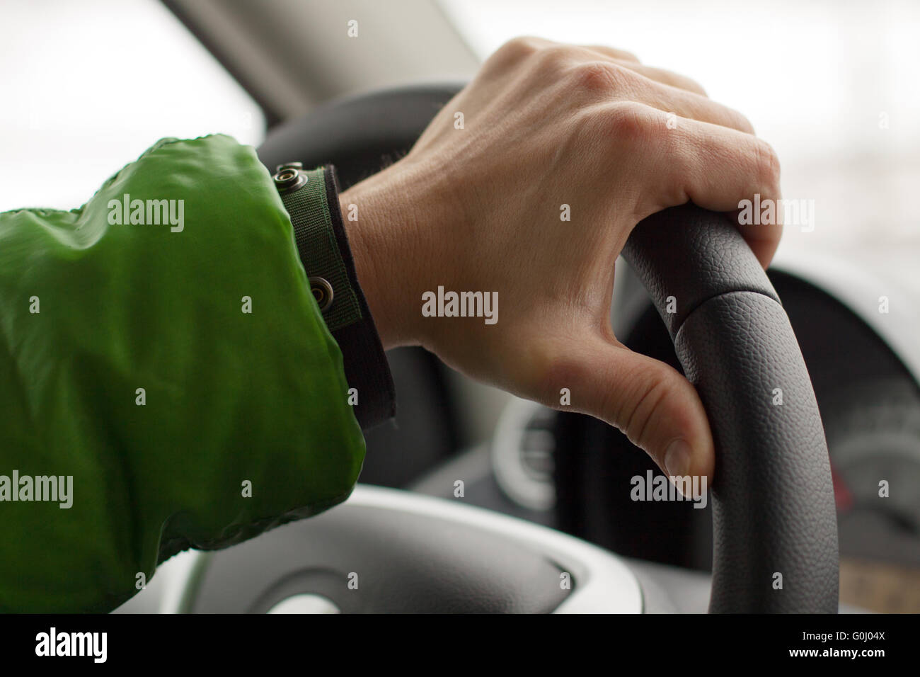 hand on wheel man is driving a car Stock Photo - Alamy